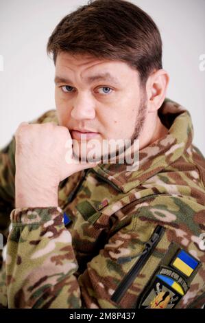 Ukrainian soldier leaned his head on his hand and thought he looks down ...