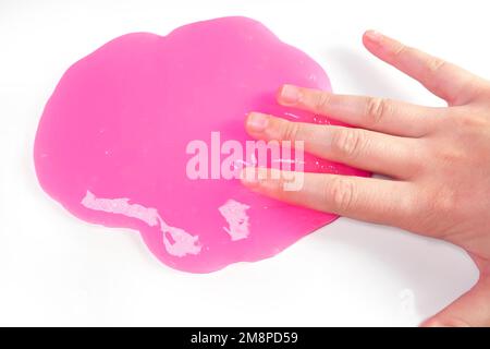 Hand Playing with textured slime on white background. Teen hand holding ...