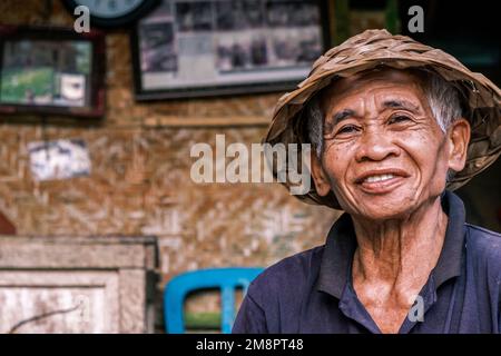 Smiling Balinese man wearing the traditional udeng head dress at a ...