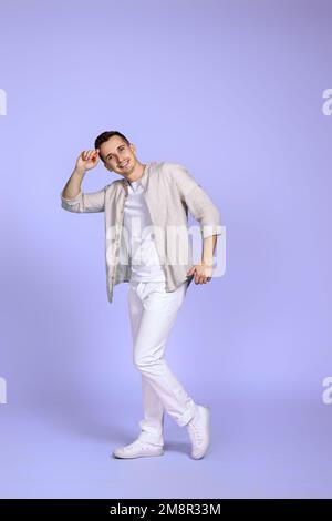 happy man dancing on pastel violet background Stock Photo - Alamy