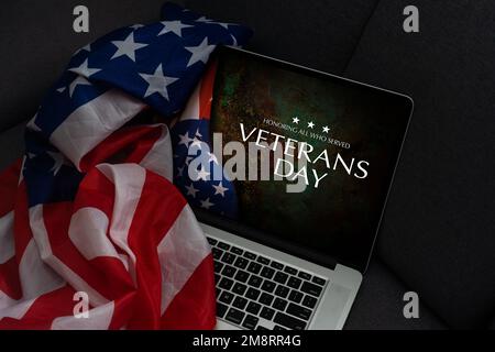 veterans day written in laptop with flag of the United States, on a ...