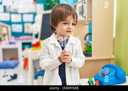 Adorable toddler smiling confident standing by christmas tree at home ...