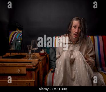 Priest with alcohol wine bottles in living room with color dark sofa ...