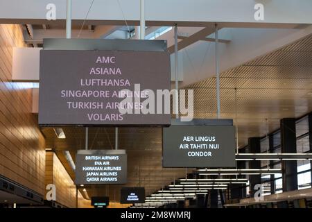 Signs direct passengers to various airlines ticket counter areas at ...