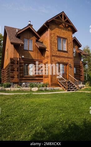 Side and rear view of Scandinavian style log home with vertical wood ...