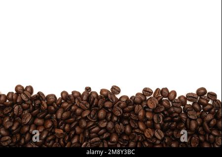 A top view of a pile of coffee beans on blue background with copy space ...