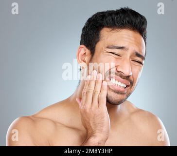 Young man suffering from back pain on sofa at home Stock Photo - Alamy