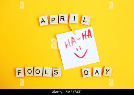 inscription April made by wooden cubes on a yellow background Stock ...