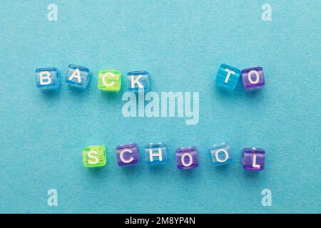 The inscription back to school made by multicolor plastic cubes on a ...