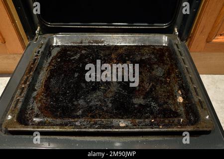 Dirty baking tray inside a home oven needs cleaning Stock Photo - Alamy