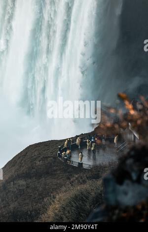 Niagara Falls vertical detail of tourists getting covered in mist by ...