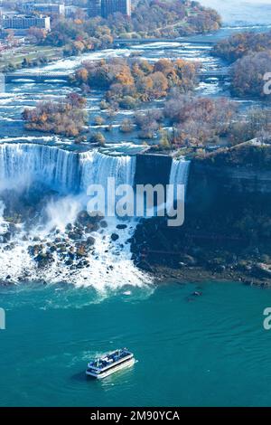 An aerial shot of Niagara Falls and a cruise full of tourists admiring ...
