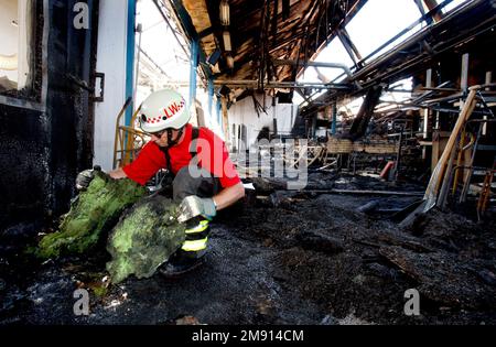 A rescue commander inside a building after a fire Stock Photo - Alamy