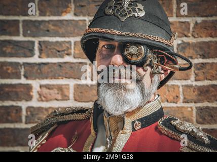 Portrait of man with monocle and helmet Stock Photo - Alamy