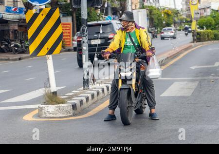 A man with a motorcycle is standing at the intersection Stock Photo - Alamy