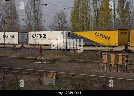 Articulated lorry trailers carried with shipping containers on a ...