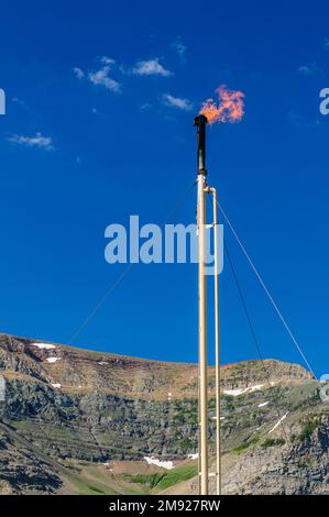 A flare stack on top of a sour gas well in the Rocky Mountains of ...