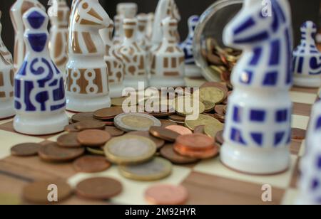 euro coins on the chessboard and among the chess pieces Stock Photo - Alamy