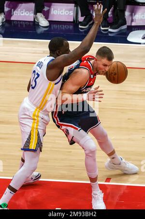 Golden State Warriors center James Wiseman, right, dunks the ball over ...
