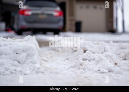 Snowbank at the end of a driveway left after city snowplows cleared a ...