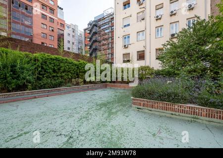 Common areas of an inner courtyard of a block with gardens, a basket to ...