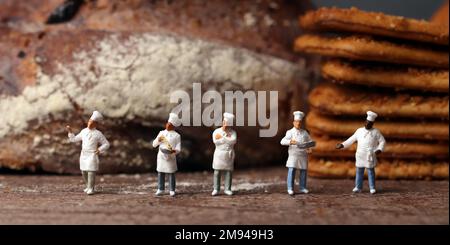 Roasted bread and five miniature chefs. Miniature people and business ...