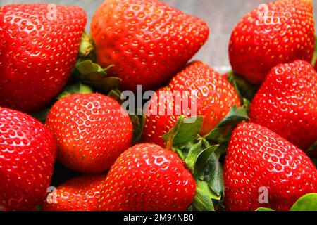 Select fruit, red strawberries in plastic packaging, vintage gray wood ...