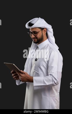 Male model in Arab Qatari dress on isolated background. Portrait of ...