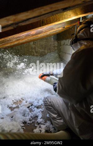 Insulation of an attic with cellulose wadding Stock Photo - Alamy