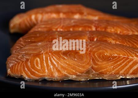 Smoked salmon steaks in closeup on wooden board Stock Photo - Alamy