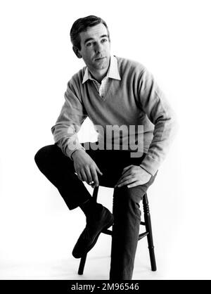A young man poses on a stool Stock Photo - Alamy