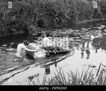 Boys on wooden raft Stock Photo - Alamy