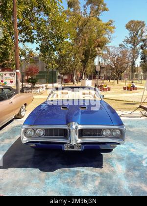 Old blue sport 1969 Pontiac GTO two door convertible in a park. Front ...