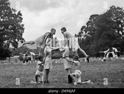 Groups of boys doing acrobatics in a field Stock Photo - Alamy