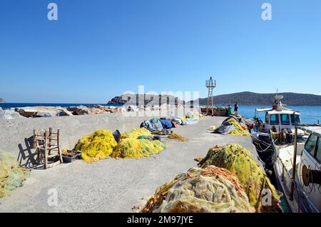 Greece, Crete, mole with fishing nets and boats in the port of Plaka ...