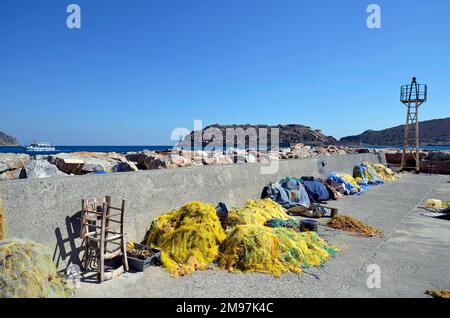 Greece, Crete, mole with fishing nets and boats in the port of Plaka ...
