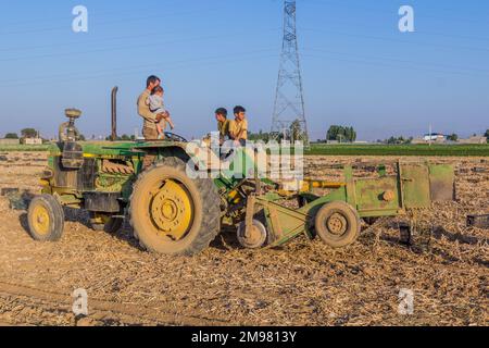 BAHAR, IRAN - JULY 13, 2019: Farmer family on their tractor near Bahar ...