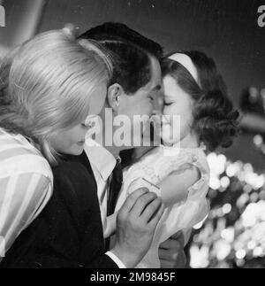 Advertisement for Remington shavers -- three models posing as a happy ...