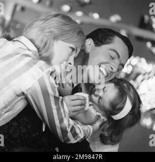 Advertisement for Remington shavers -- three models posing as a happy ...