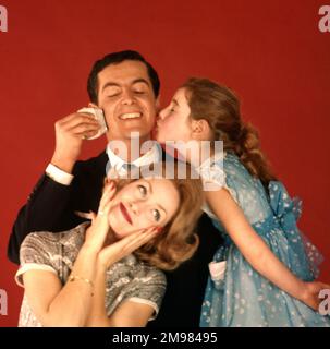 Advertisement for Remington shavers -- three models posing as a happy ...