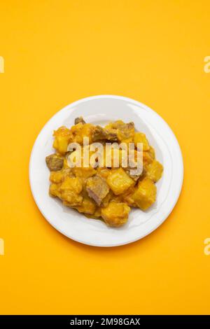 Tasty beef baked with potatoes and stewed peppers served Stock Photo ...