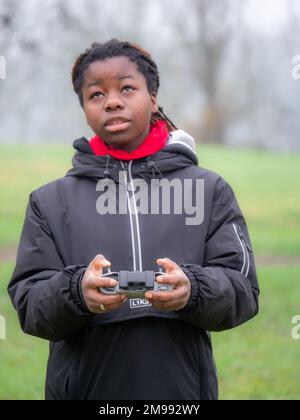 Cheerful young teengaer african american dressed in sportswear flying a ...