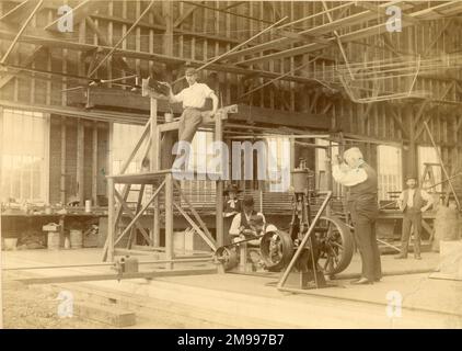 Sir Hiram Maxim operating the valve of the steam engine during a ...