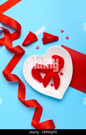 Fortune cookies with red ribbon on dark wooden background, closeup ...