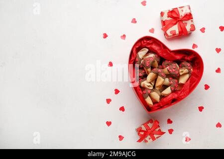Box with fortune cookies, gifts and hearts on white background ...