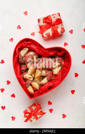 Box with fortune cookies, gifts and hearts on white background ...