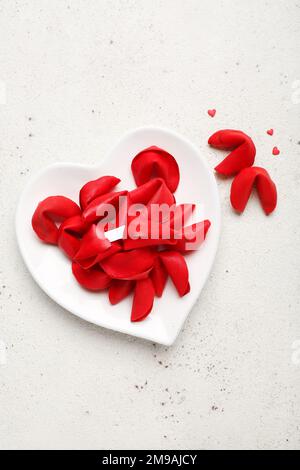 Plate with red fortune cookies on light background, closeup. Valentine ...