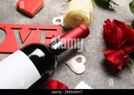 Bottle of wine, rose flowers and hearts on pink background. Valentine's ...