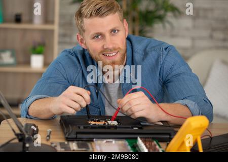 Repairman working in technical support fixing computer laptop ...