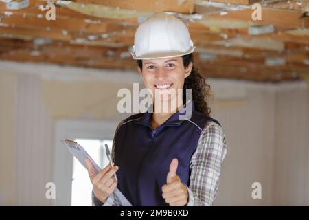 builder woman shows thumbs up Stock Photo - Alamy